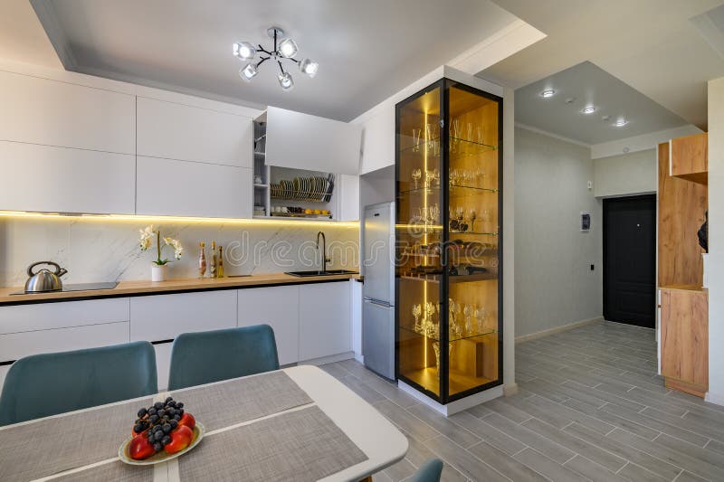 A Sleek White Studio Apartment with a Fully Functional Kitchen Stock ...