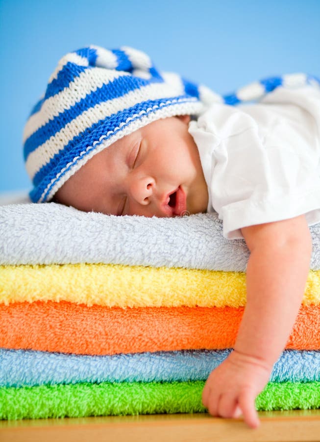 Sleeping Baby on Colorful Towels Stack Stock Image - Image of child ...