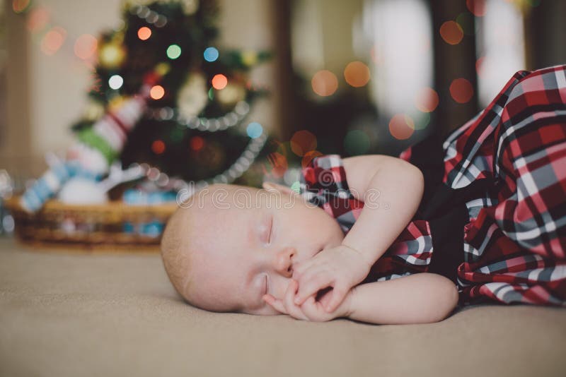 Sleeping Baby Near Christmas Tree Stock Image - Image of soft, girl ...