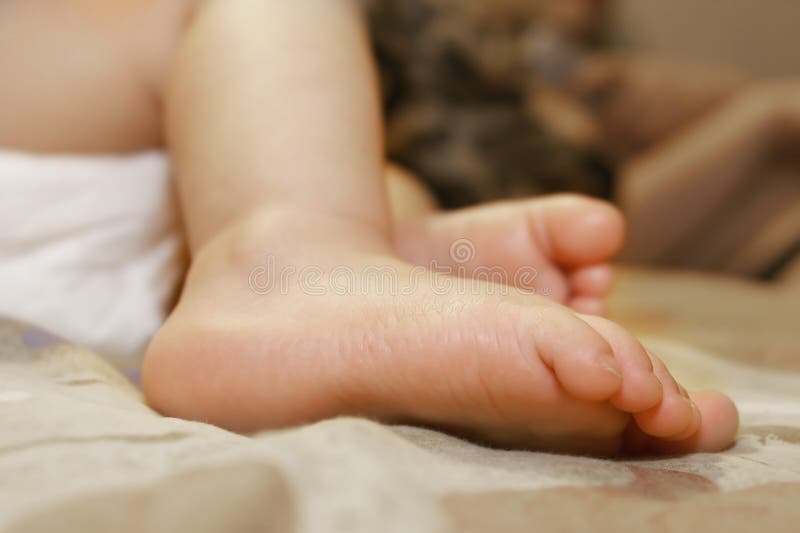 Sleeping baby s feet stock image. Image of parenting, linen - 4705581