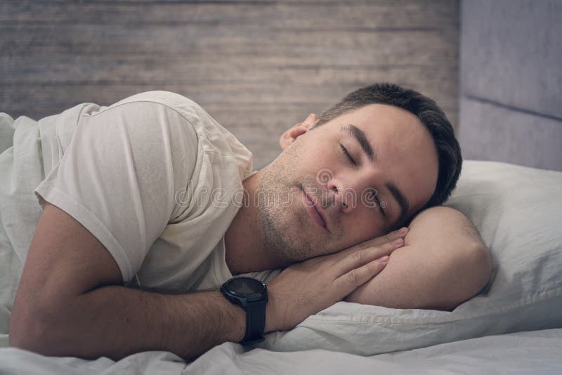 A Satisfied Expression on His Face. Young Guy is Resting in Bed with a ...