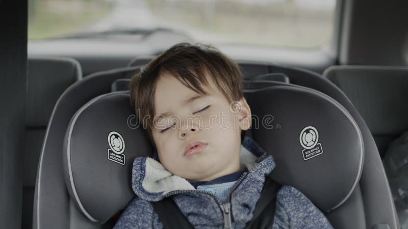 A Sleeping Boy of Two Years Old Rides in a Car Seat Stock Image - Image ...