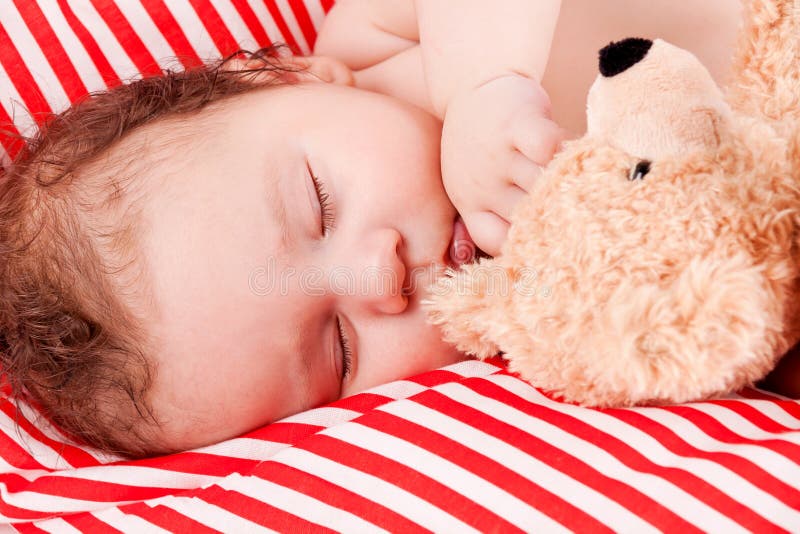 Sleeping Cute Little Baby on Red and White Stripes Pillow Stock Image ...