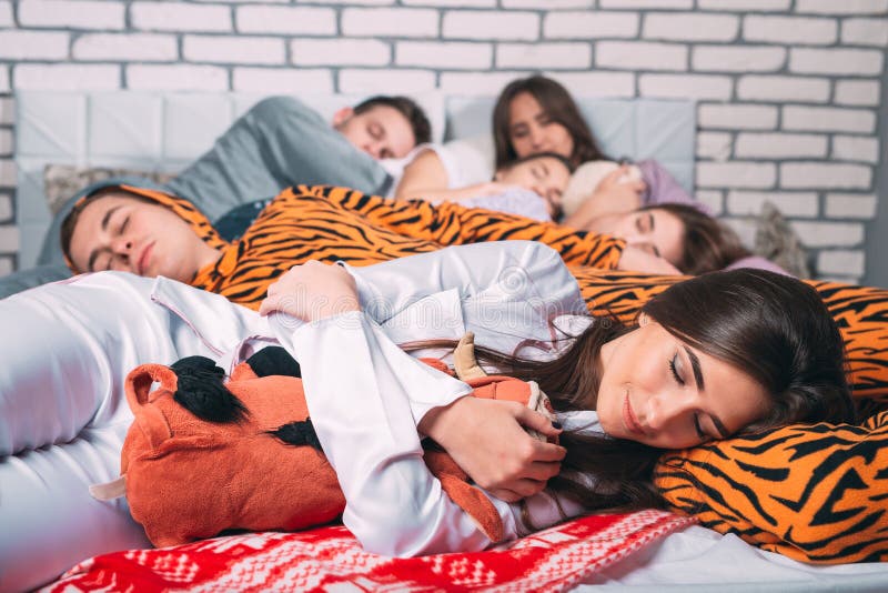 Sleeping Group of Young People on the Bed. Stock Photo - Image of ...