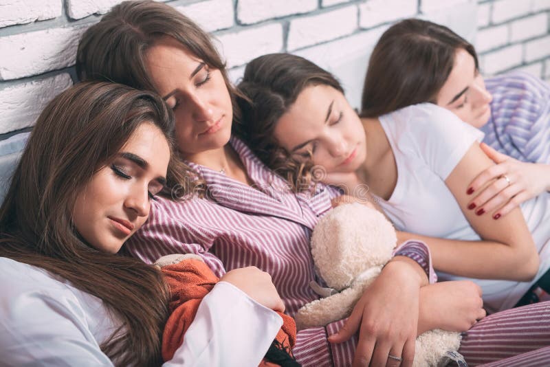 Sleeping Group of Young People on the Bed. Stock Photo - Image of ...