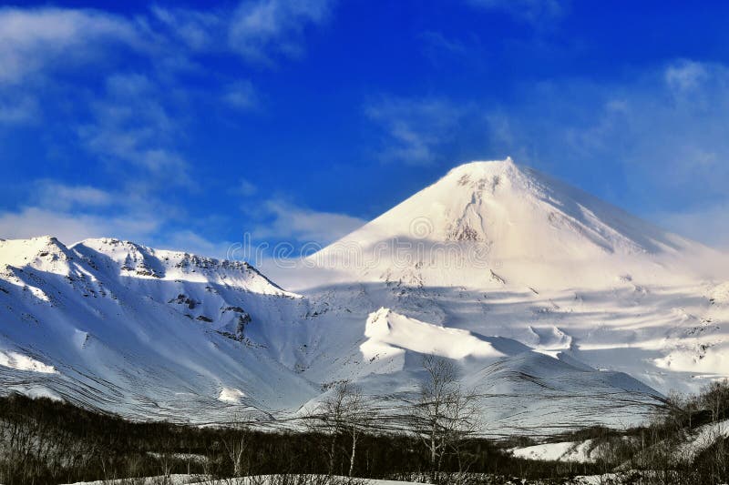 Sleeping Snow-covered Volcano in the Rays of the Setting Sun. Mountain ...