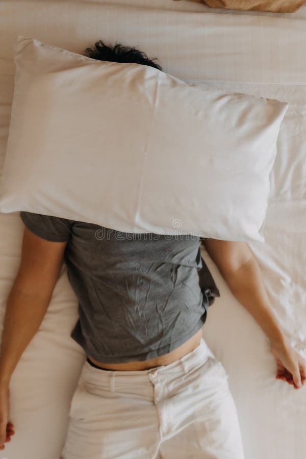 Sleepy Man Keep on Sleeping on the Bed, Using Pillow Covering His Face ...