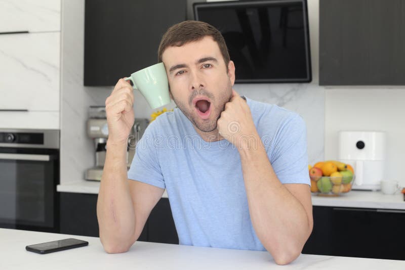 Sleepy Looking Man Holding Coffee Cup in the Kitchen Stock Image ...