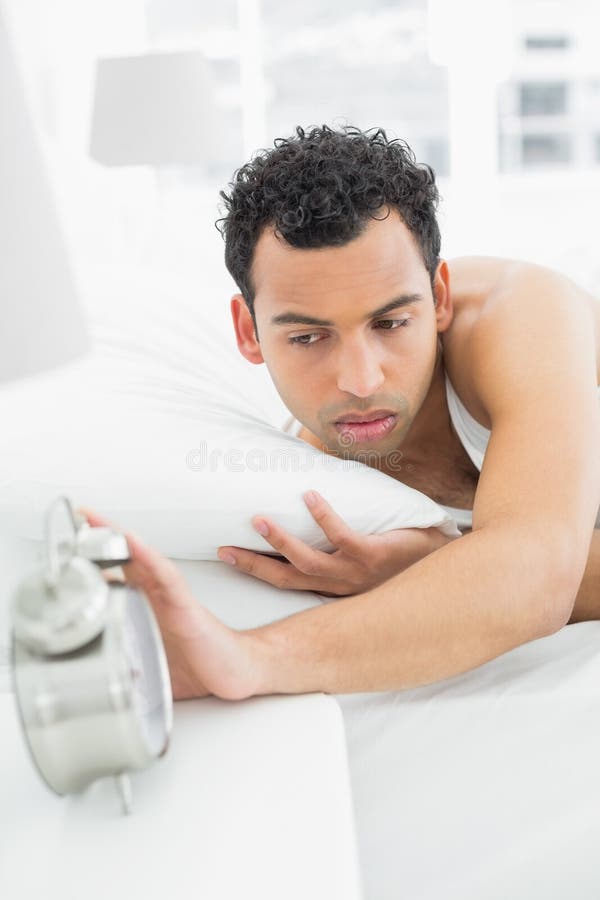 Sleepy Man Extending Hand To Alarm Clock Stock Photo - Image of house ...