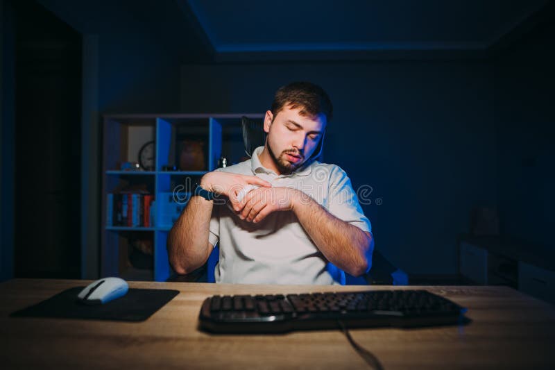 Sleepy Man Sleeps at the Computer Desk during Night Work. Tired ...