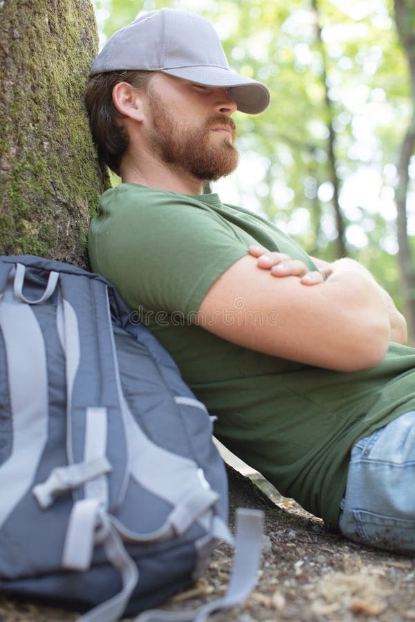 Sleepy man under tree stock image. Image of relax, sitting - 250318323