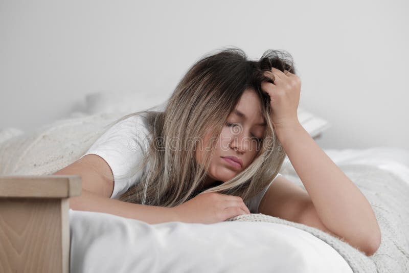 Sleepy Young Woman in Bed at Home Stock Photo - Image of restless ...