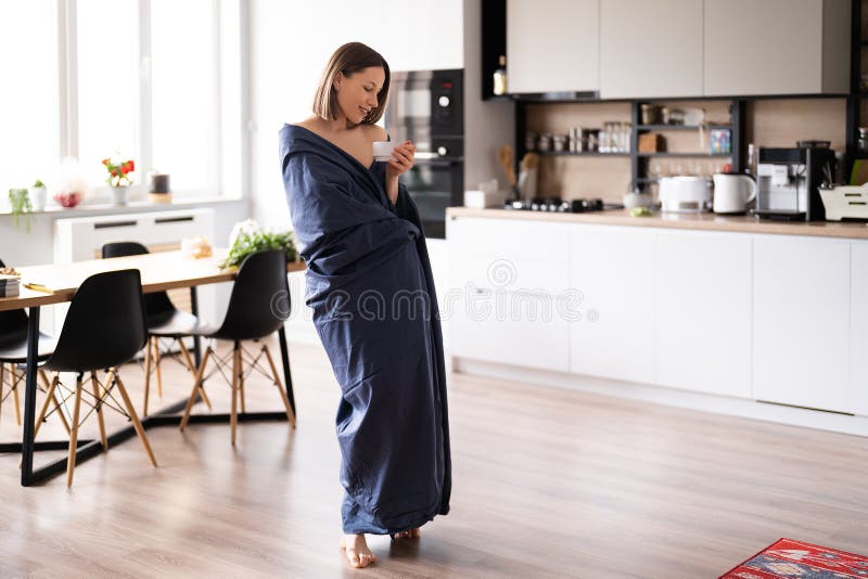 Sleepy Woman Drinking Coffee In The Morning In The Kitchen Stock Image