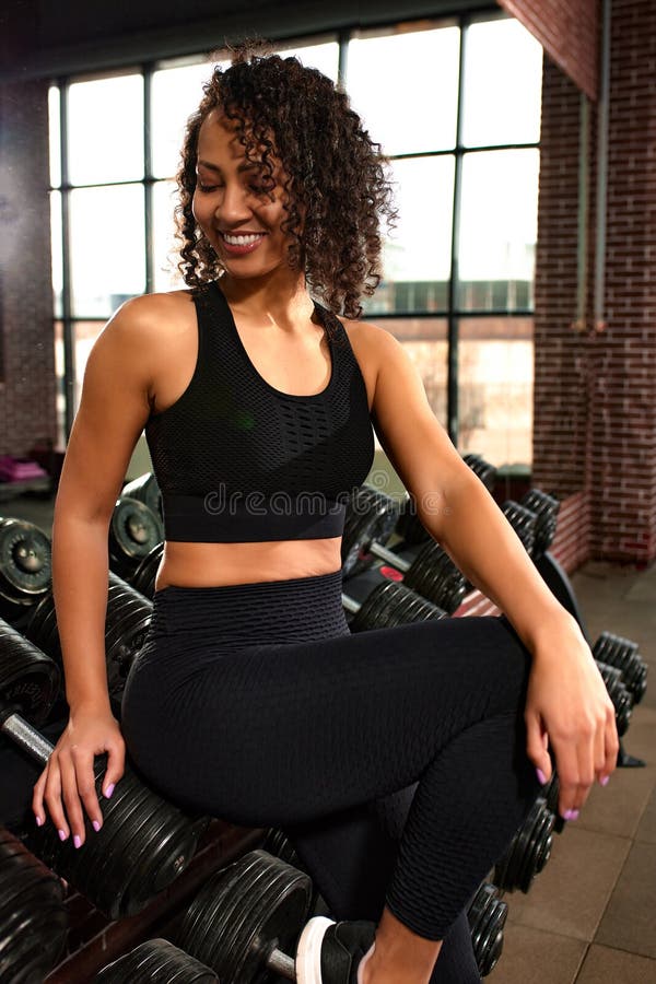 Slender Athletic African American Woman In Sportswear Smiling At The