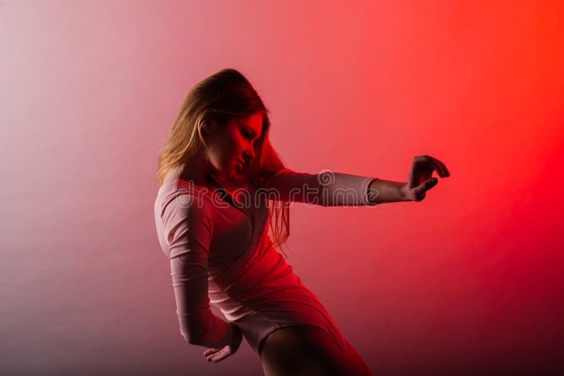 Slender Female on a Coloured Background of Neon Color Posing in a ...