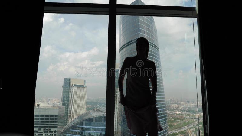 Slender Woman Dance at a Panoramic Window in Front of a Skyscraper ...