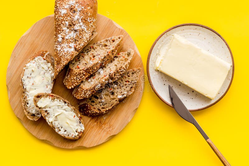 Slice of Bread with Butter on Yellow Table Stock Image - Image of ...
