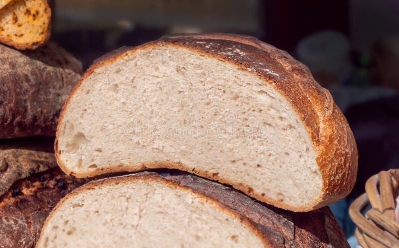 A Slice of Bread is Cut in Half, Revealing the Inside of the Loaf Stock ...