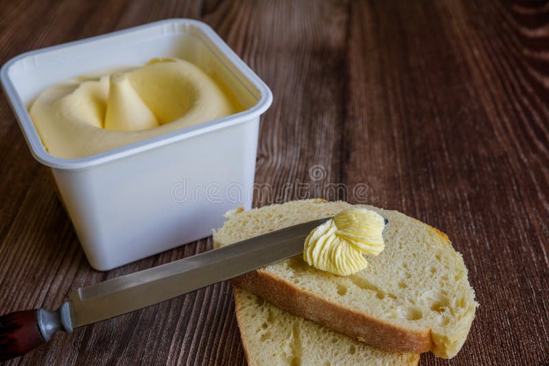Slice of Bread Spread with Creamy Butter. Stock Image - Image of ...
