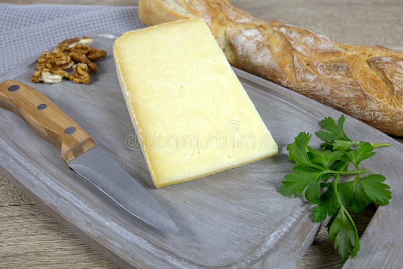 Slice of Cantal Cheese on a Table Stock Photo - Image of table ...