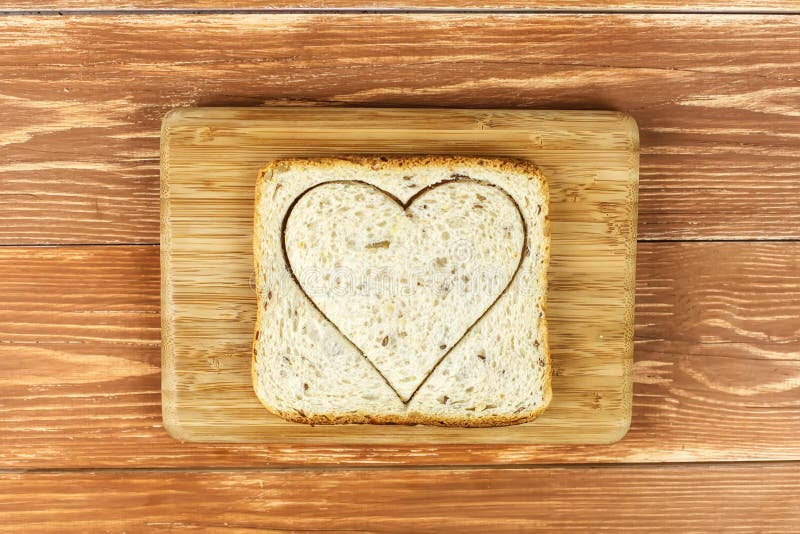 Slice of Cereal Toast Bread with Cut Out Heart Stock Image - Image of ...