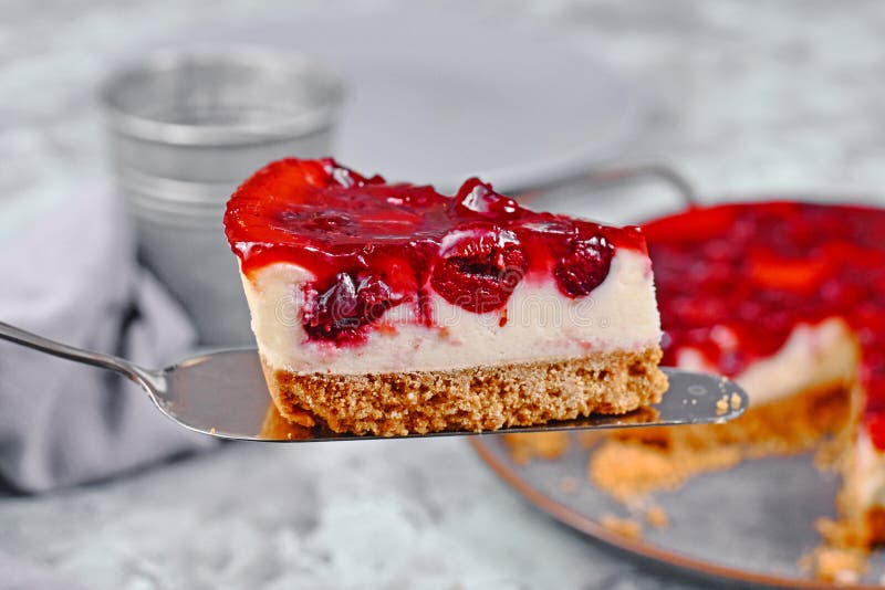 Slice of Cheesecake Glazed with Cherry Fruit Topping on Cake Server ...
