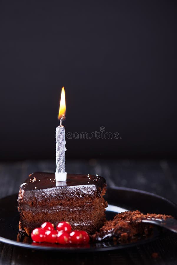 Slice of Chocolate Cake with a Single Lit Candle. Stock Photo - Image ...