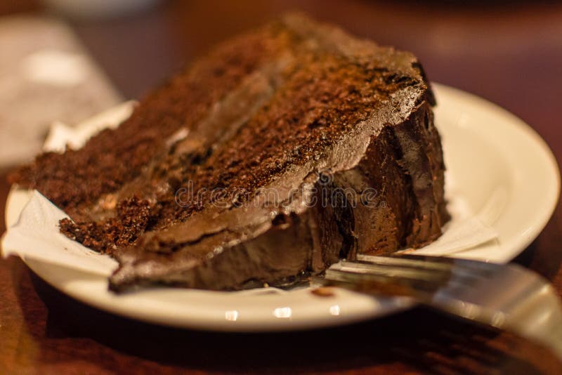 Slice of Chocolate Fudge Cake with Fork on a Plate B Stock Photo ...