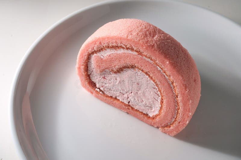 Slice of a Delectable Pink Swiss Roll Cake on a White Plate Stock Image ...