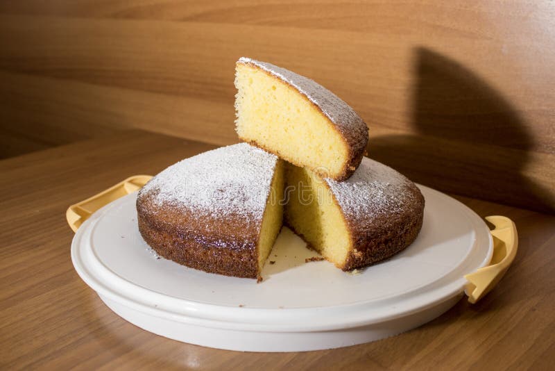 Slice of a Delicious Cake with Powdered Sugar on a Wood Table Stock ...