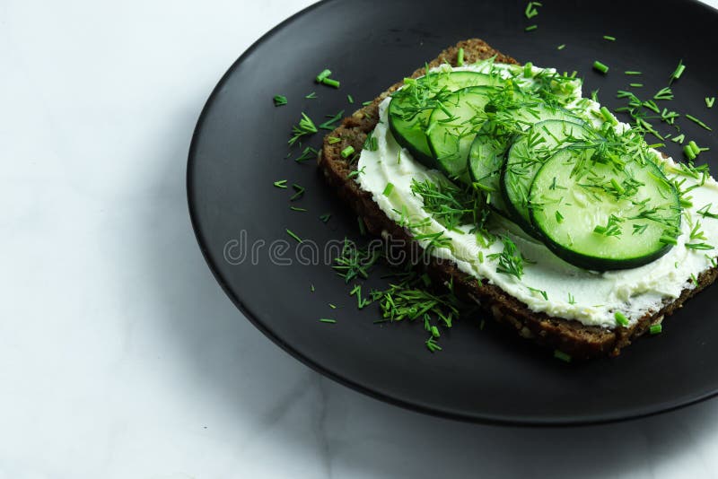 Slice of Dense Rye Bread with Cream Cheese, Cucumber and Dill Stock ...