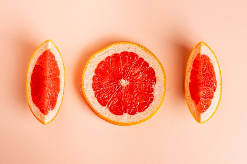 Slice of Grapefruit in the Middle of Two Pieces of the Same Fruit on a ...