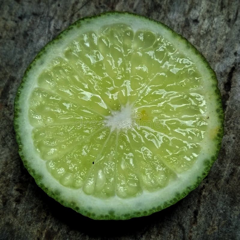 Slice of Green Lime on Grey Background with Rough Texture Stock Image ...