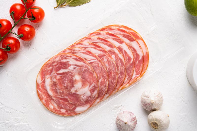 Slice of Italian Ham and Meat in Vacuum Package, on White Stone Table ...