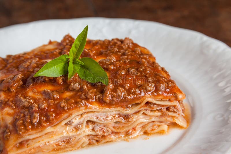 A Slice of Lasagna on a Wood Table Stock Photo - Image of fresh ...