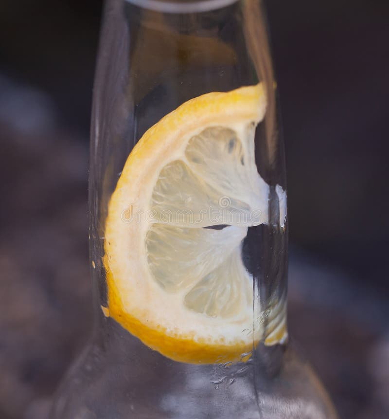 Slice of Lemon in a Bottle. Stock Photo - Image of tonic, outdoors ...