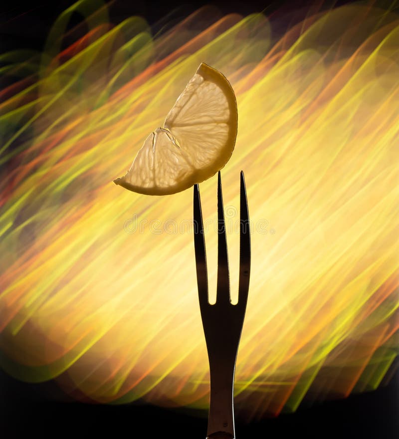 A slice of lemon on a fork stock image. Image of wing - 312797249