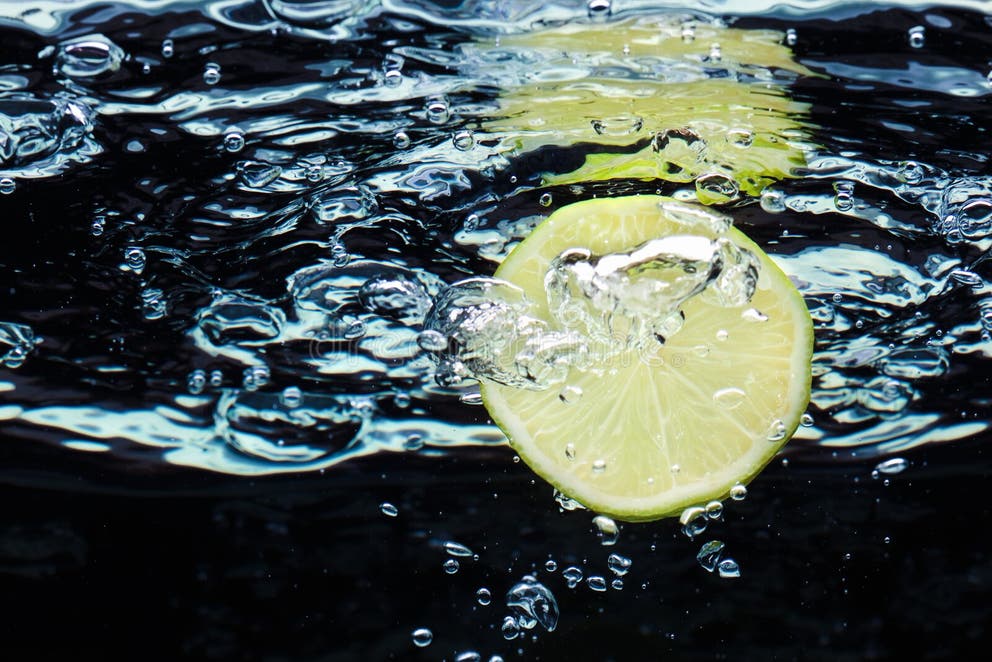 Slice of Lime (lemon) Falling in Water Stock Image - Image of close ...