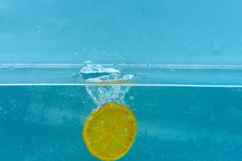 Slice of Orange Under Water with Transparent Bubbles and Water Drops ...