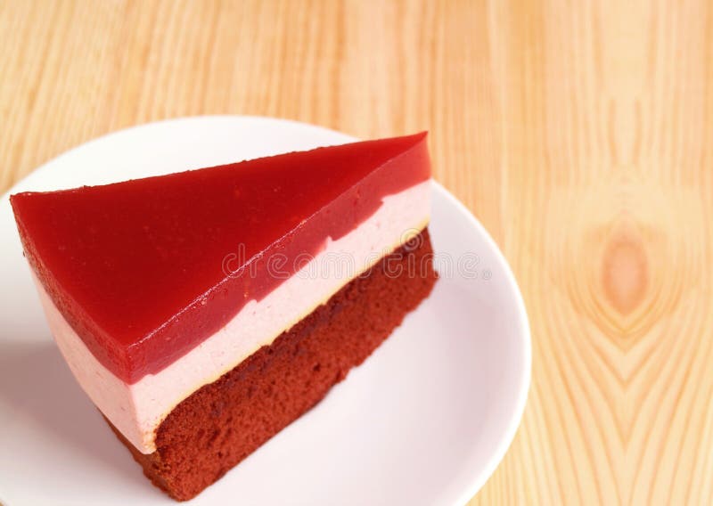 Slice of Raspberry Mousse with Chocolate Layer Cake on Wooden Backdrop ...