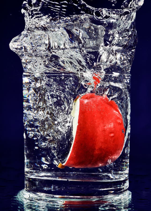 Slice of Red Apple Falling Down in Glass Stock Photo - Image of energy ...