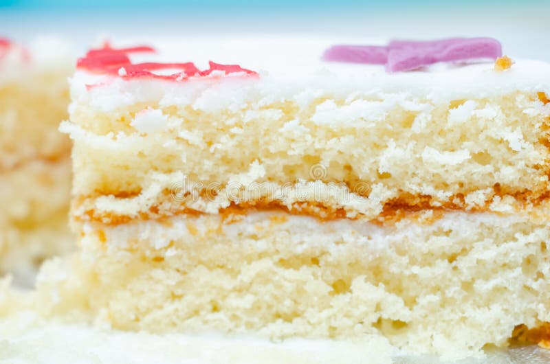 A Slice of White Cake with Color Frosting on Top Stock Photo - Image of ...