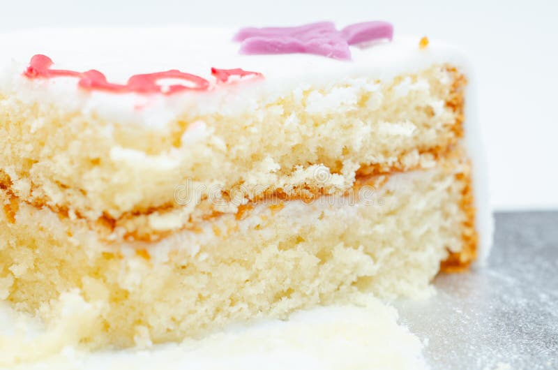 A Slice of White Cake with Color Frosting on Top Stock Image - Image of ...