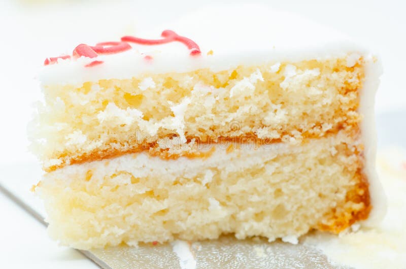 A Slice of White Cake with Color Frosting on Top Stock Photo - Image of ...