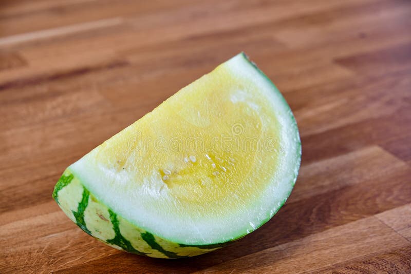 Slice of yellow watermelon stock photo. Image of board - 76404574
