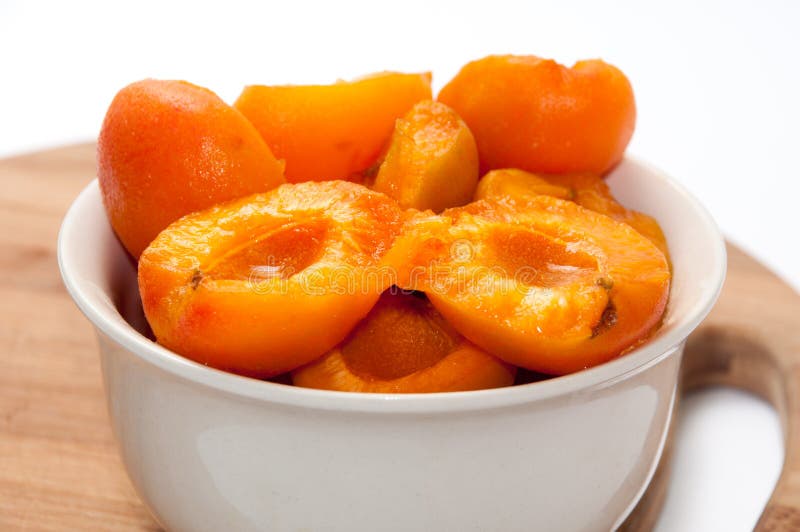 Sliced Apricots in the White Bowl on the Wooden Board Stock Image ...