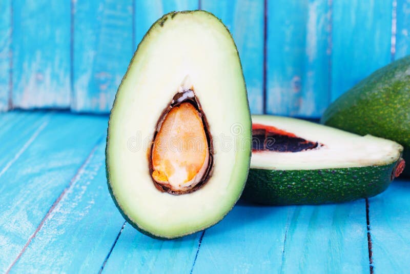 Sliced Avocado on Blue Wood Board Stock Image - Image of tropical ...