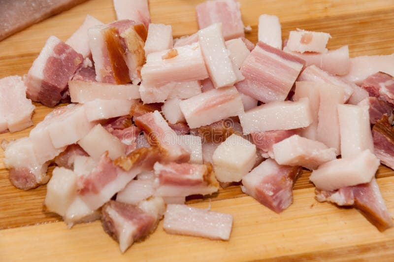 Sliced Bacon Cubes on the Wooden Cutting Board Stock Photo - Image of ...