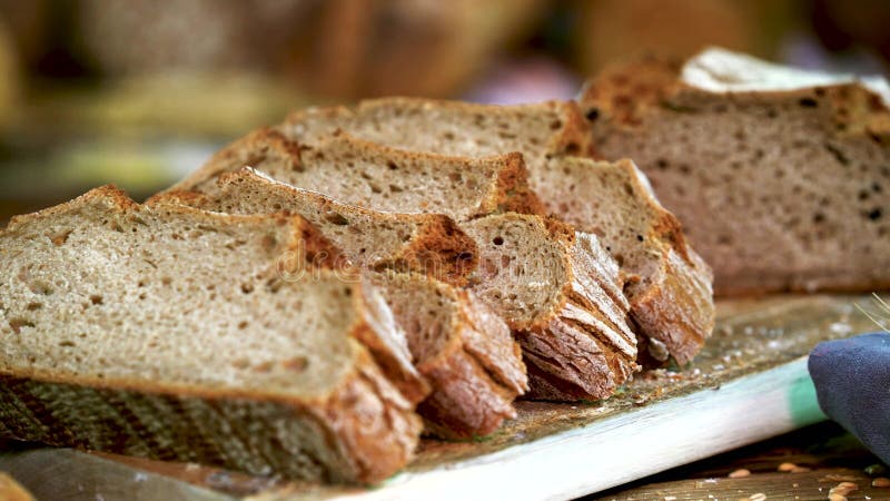 Sliced Bakery Slices of Crusty Bread in a Bakery on the Table. Stock ...