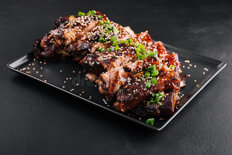 Sliced BBQ Pork Ribs on Black Plate Stock Photo - Image of barbecue ...